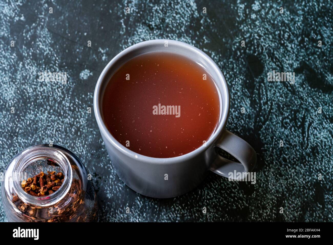 Sumac water or tea and dried ground red Sumac spices with cloves in ...