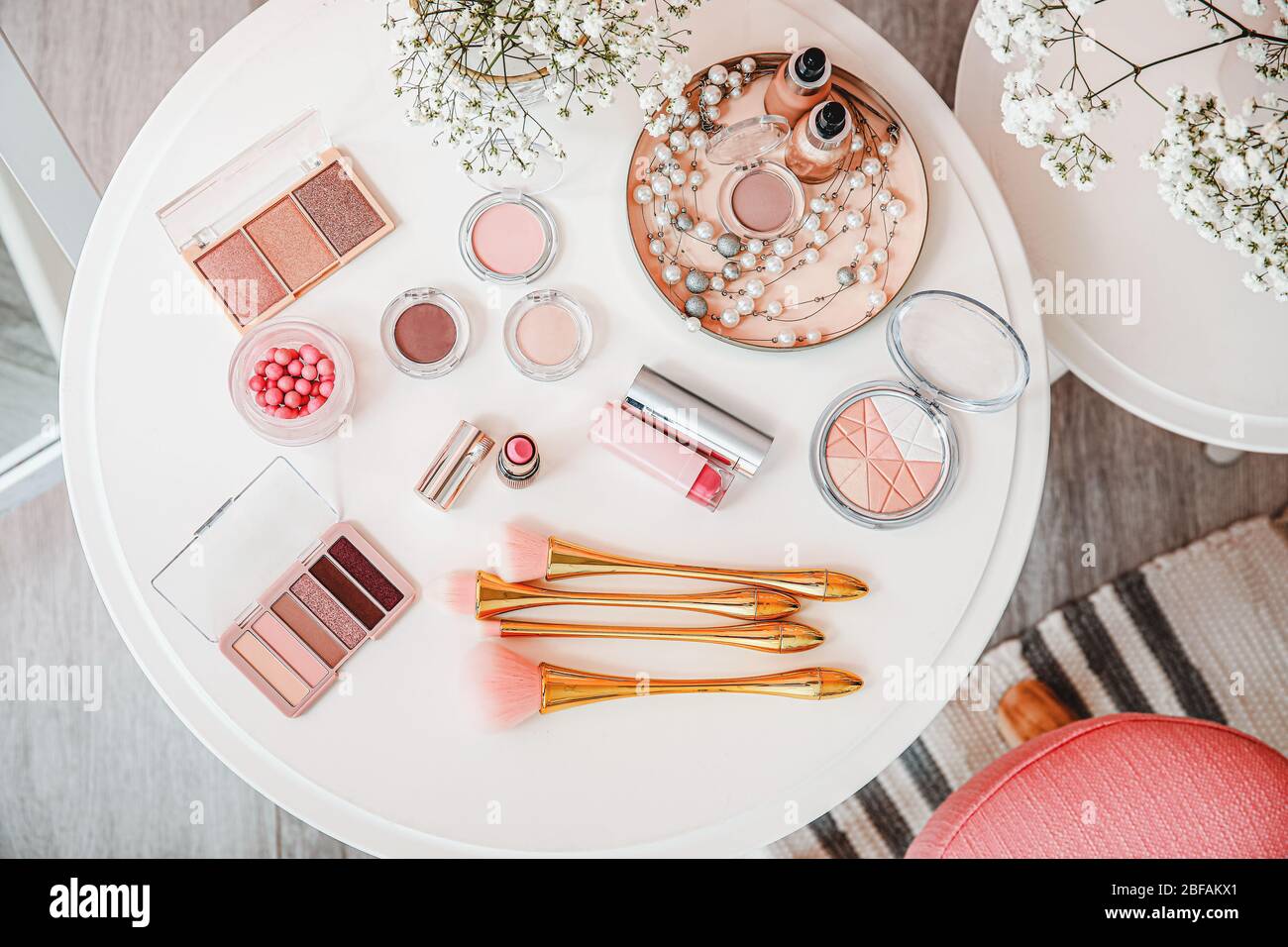Decorative cosmetics with makeup brushes on dressing table Stock Photo ...