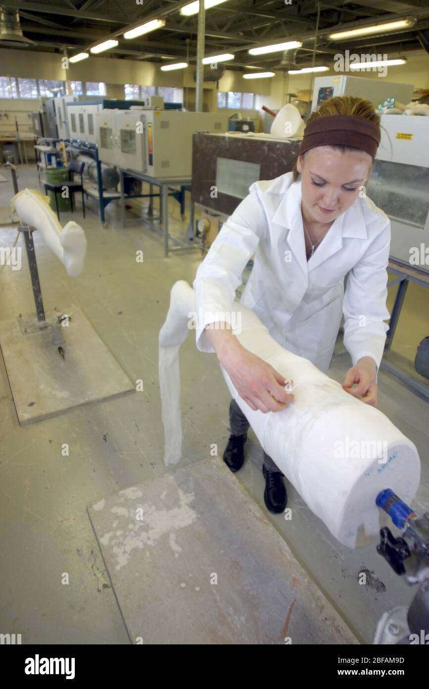 A female technician completes the plastic moulding of a plaster cast ...