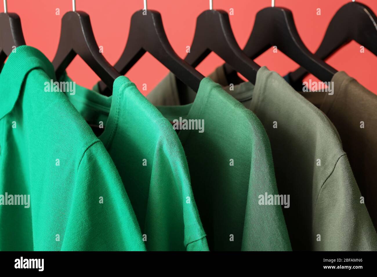 Rack with modern clothes on color background, closeup Stock Photo - Alamy