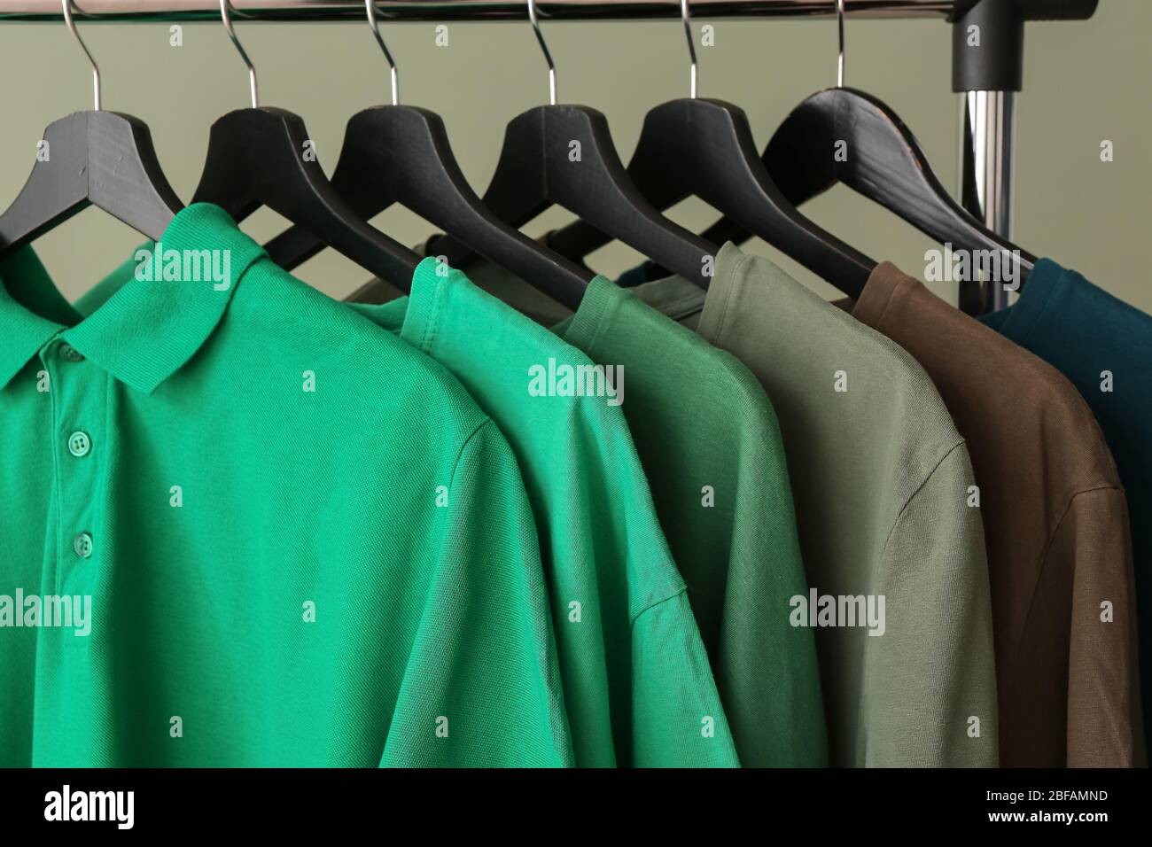 Rack with modern clothes on color background, closeup Stock Photo - Alamy