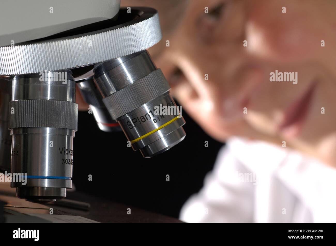 Science student using a microscope to analyse biological samples Stock ...