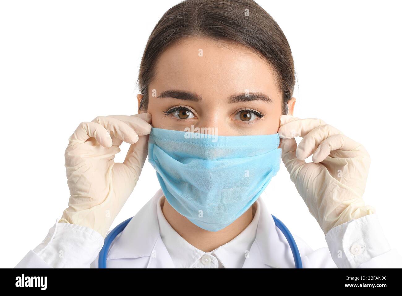 Doctor wearing medical mask against white background Stock Photo - Alamy