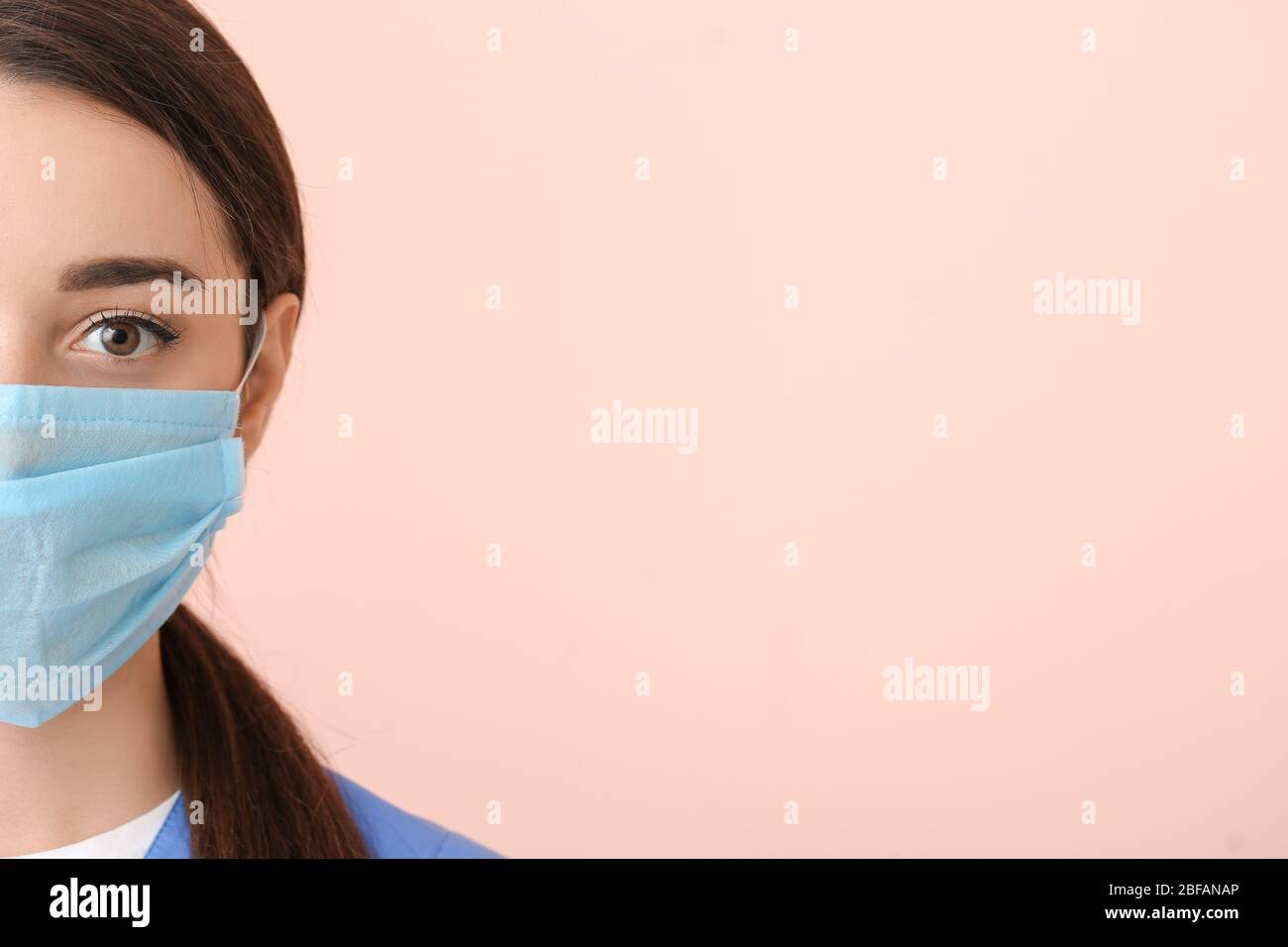 Doctor wearing medical mask against color background Stock Photo - Alamy