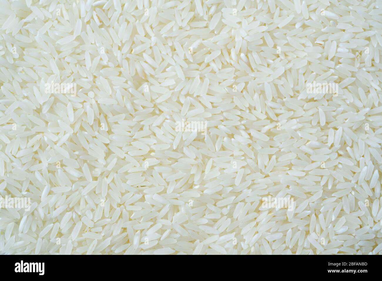 macro view of heap of rice on white background Stock Photo - Alamy