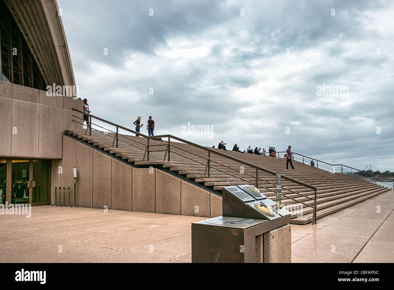 View of the main stairs of the Sydney Opera House under a dramatic sky ...