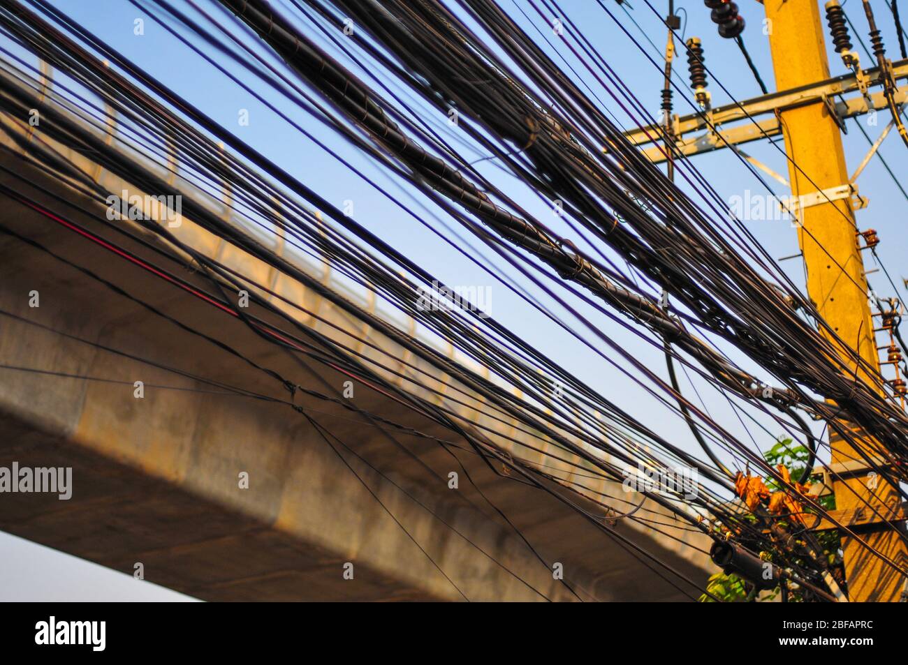 Overhead electric and telephone wires in Bangkok in Thailand Stock ...