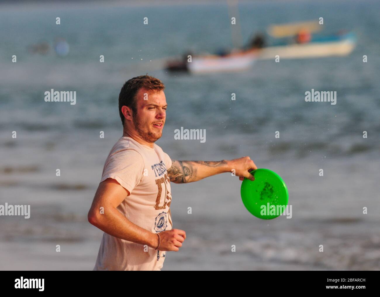 Playing frisbee and having exercise on a Chao Lao Beach in Thailand ...
