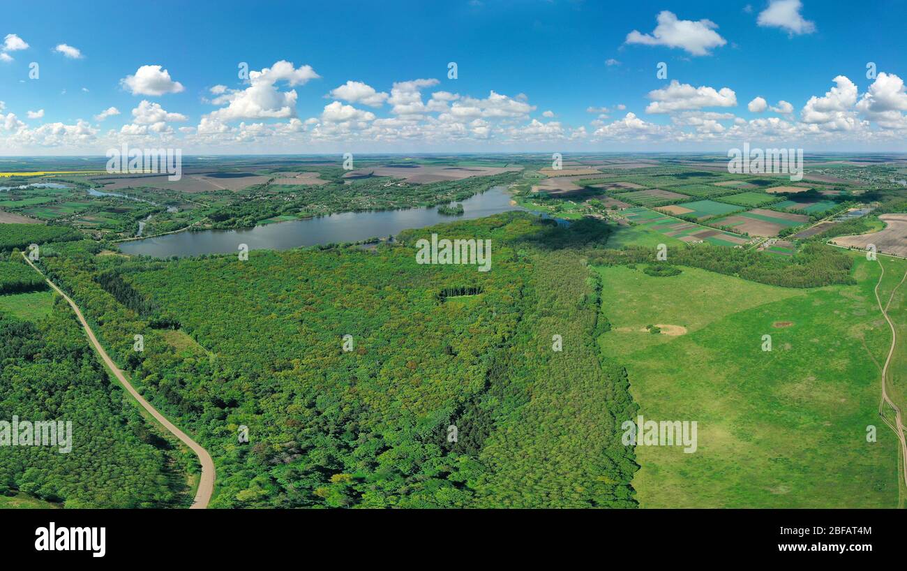 Panorama aerial view of green meadow and field near the path. gray and ...