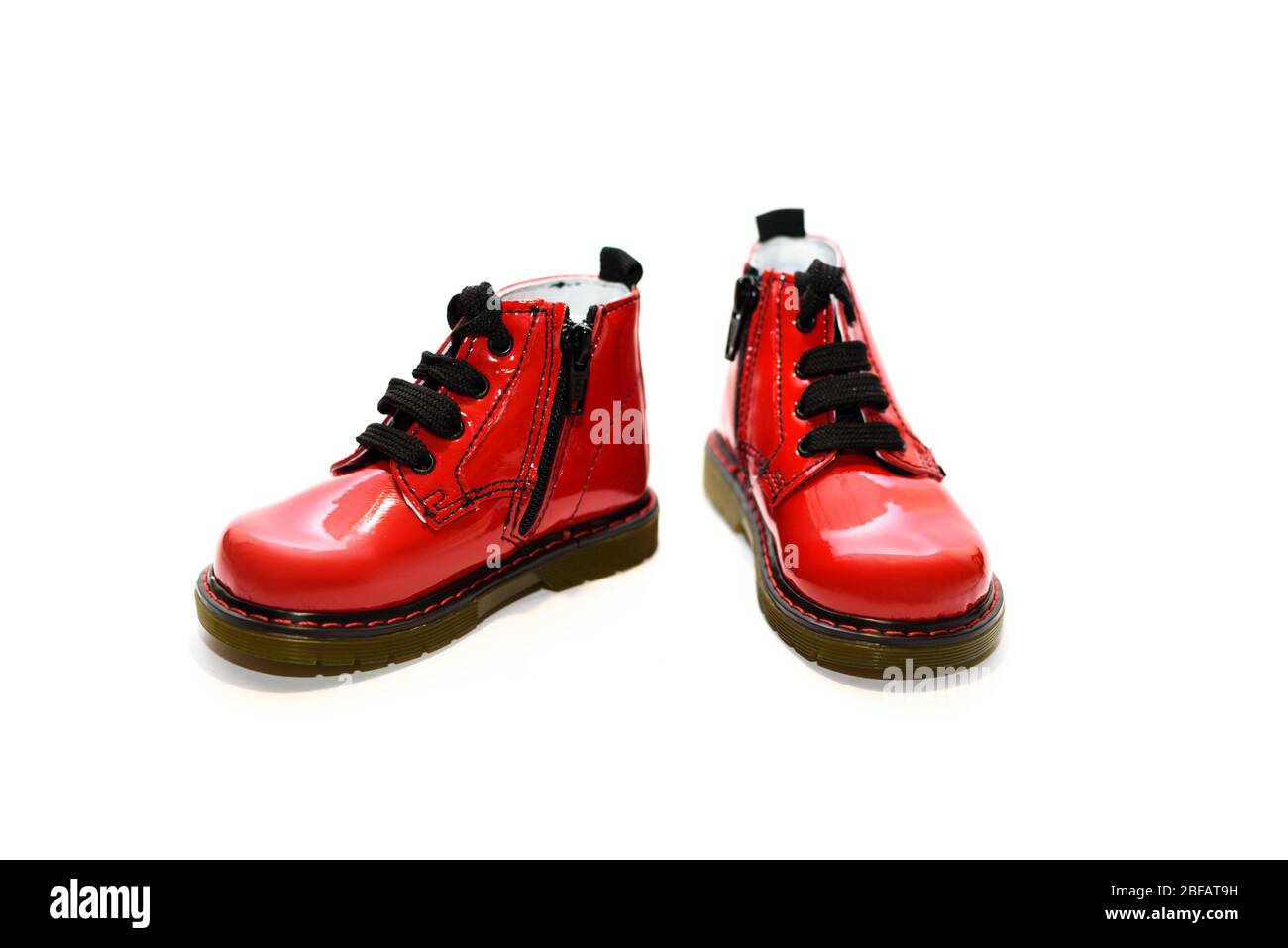 Children's beautiful shiny red boots isolated on the white background ...