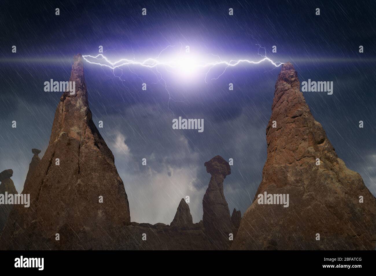 Powerful lightning discharges between peaks of two rocks in dark stormy ...