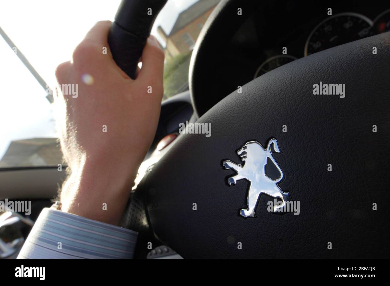 Inside a Peugeot car with hands on the steering wheel Stock Photo - Alamy