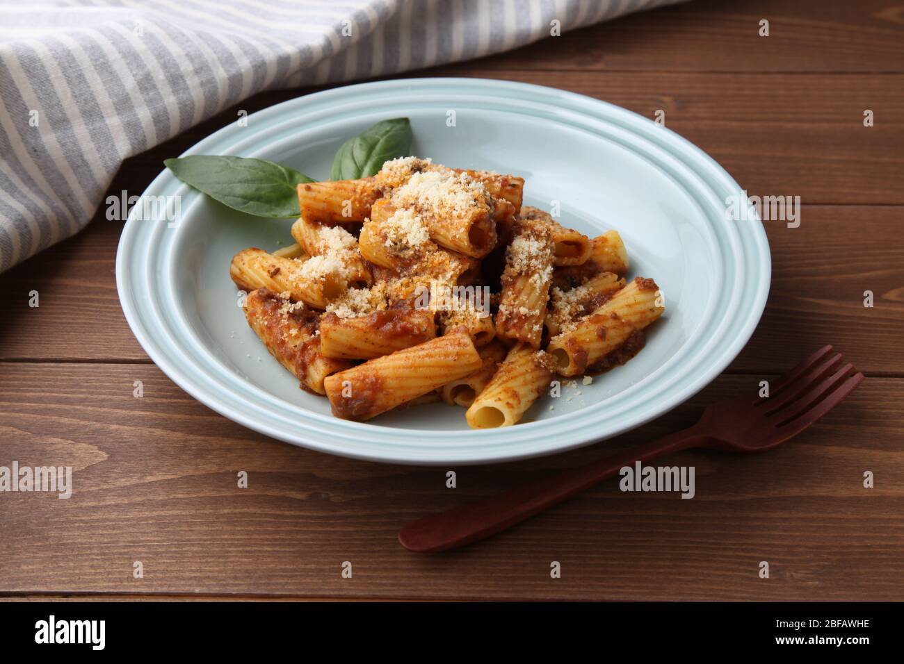 rigatoni pasta italian food on plate isolated on table Stock Photo - Alamy