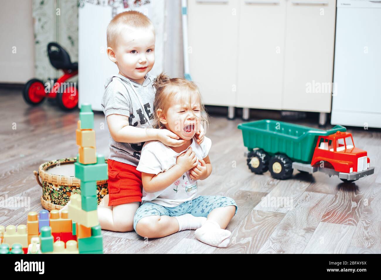 Two baby cry smile hi-res stock photography and images - Alamy