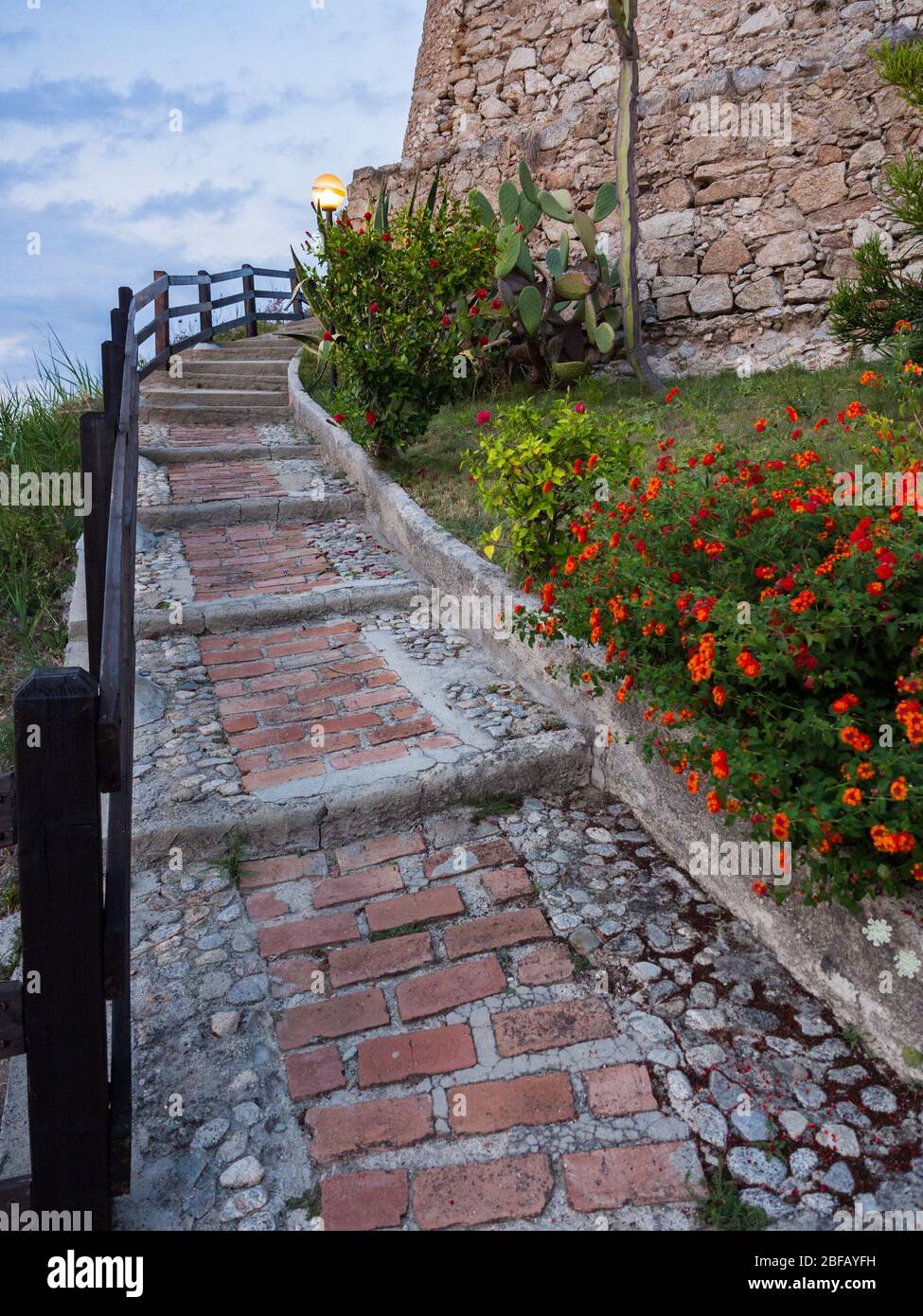 Pedestrian path leading to an ancient stone watchtower Stock Photo - Alamy