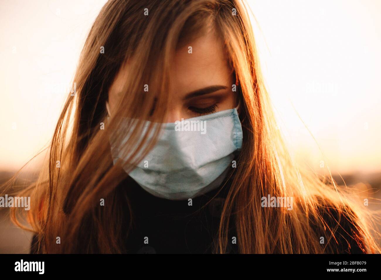 Close up portrait of sad depressed young woman wearing protective face ...