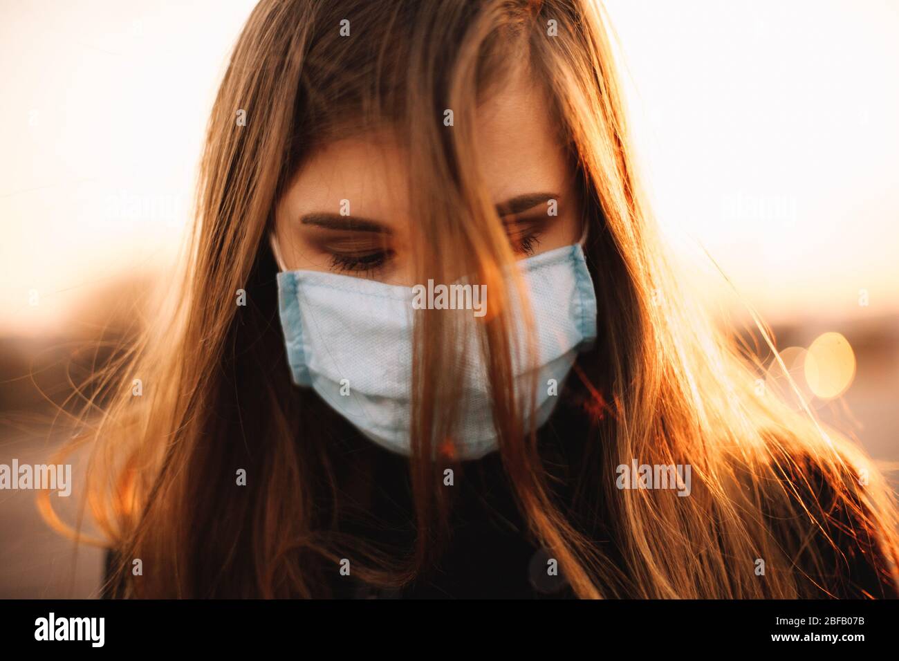 Close up portrait of sad depressed young woman wearing protective face ...
