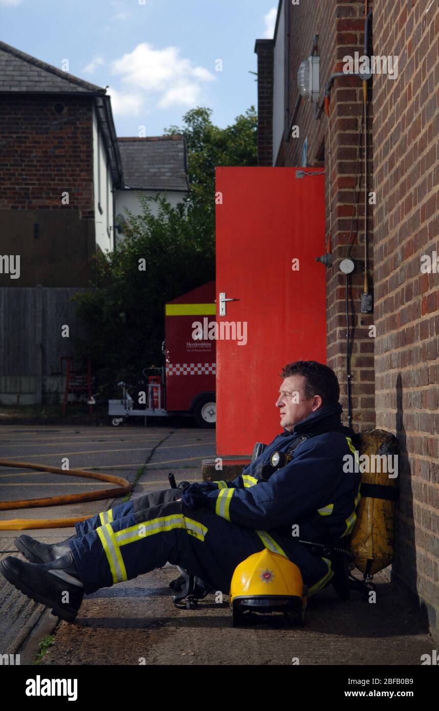 A fire fighter takes a break Stock Photo - Alamy