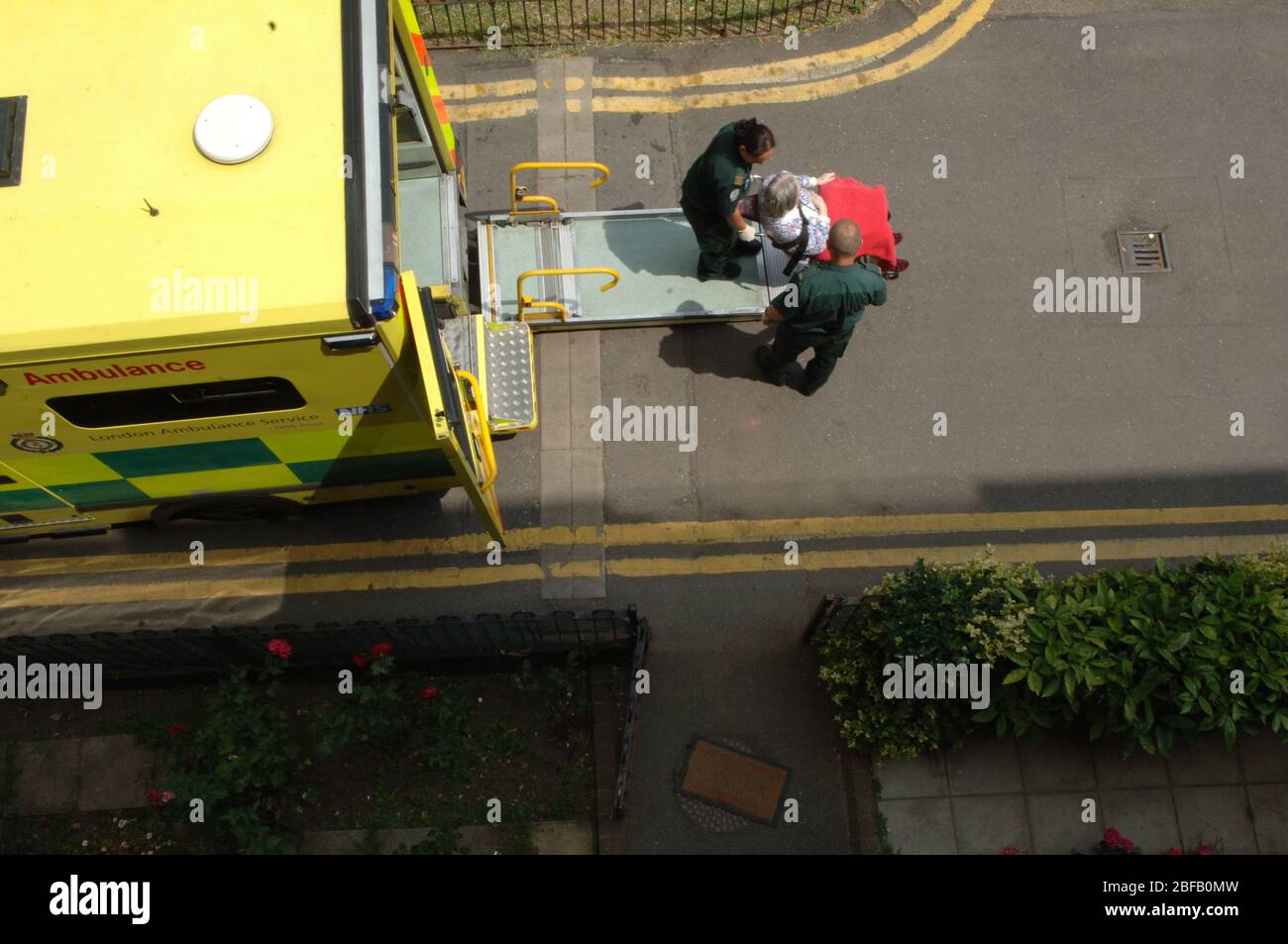 Birds eye view of paramedics loading a patient into an ambulance Stock ...
