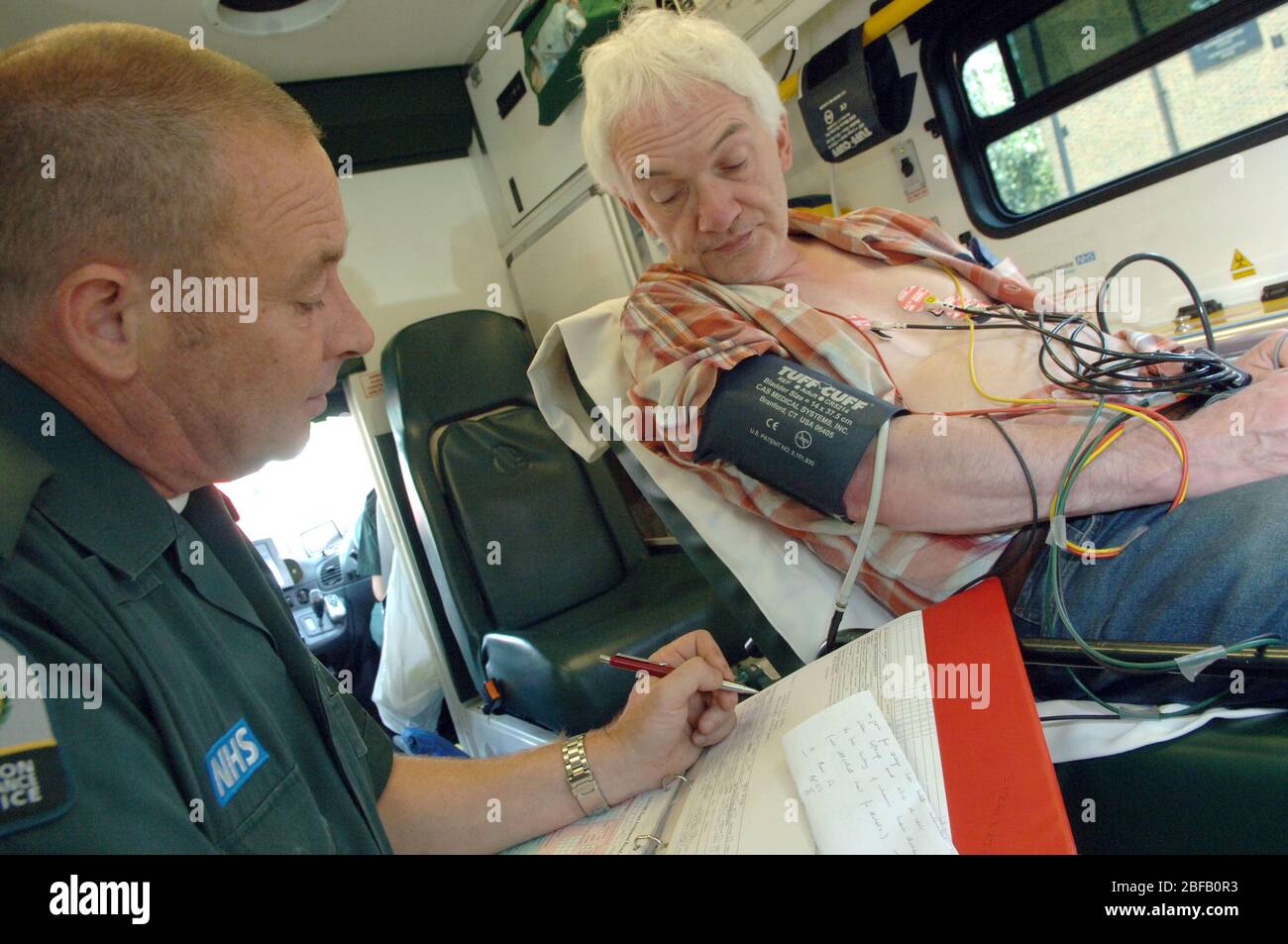 Paramedic taking notes from patient.(Model released Stock Photo - Alamy