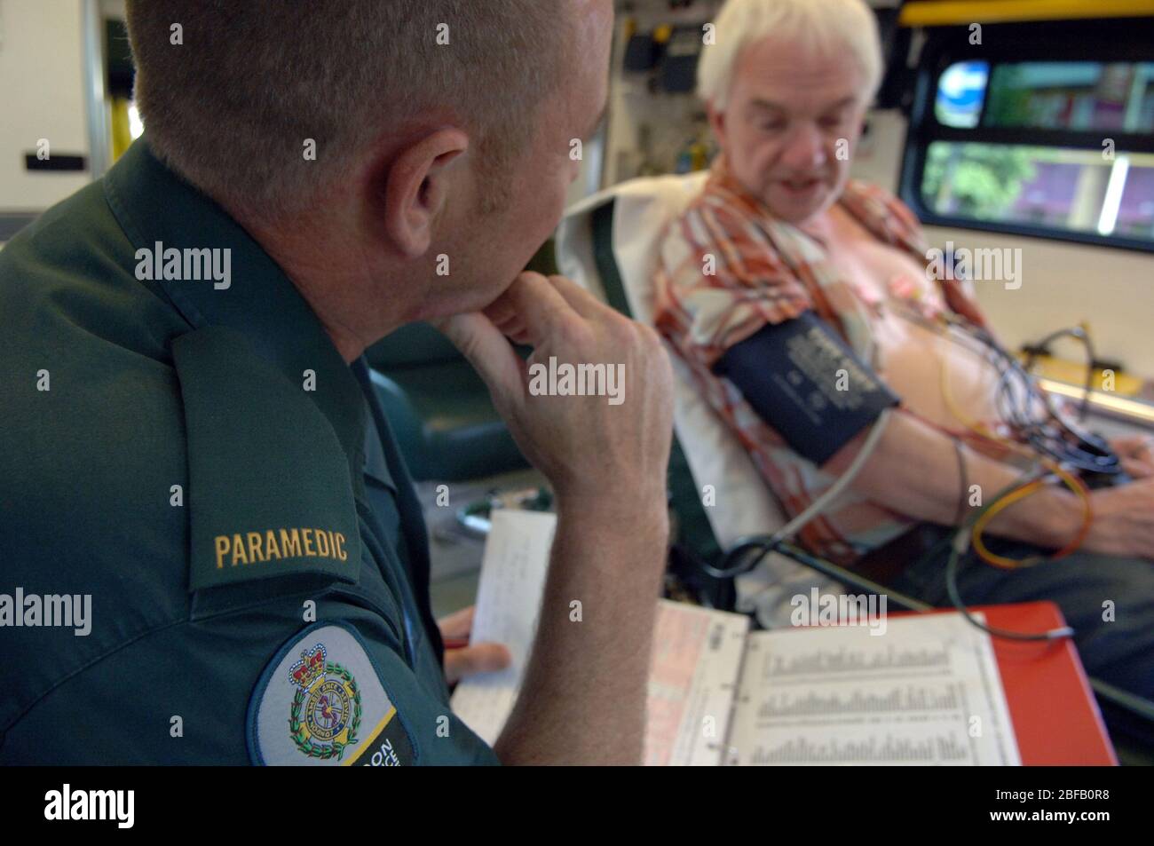 Paramedic taking notes from patient(Model released Stock Photo - Alamy