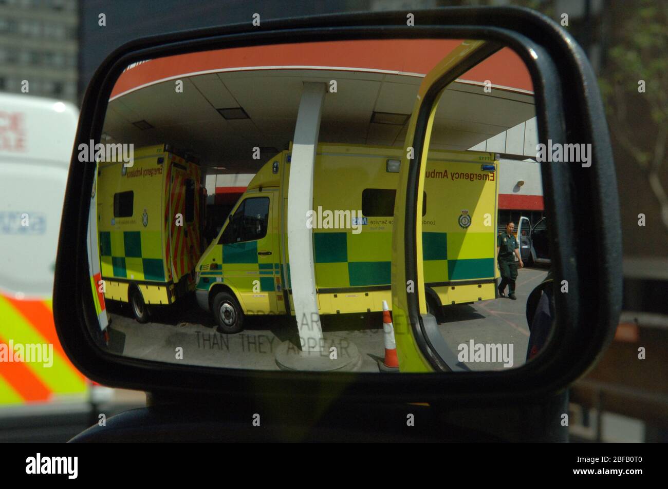 London ambulance seen in the reflection of a car mirror Stock Photo - Alamy