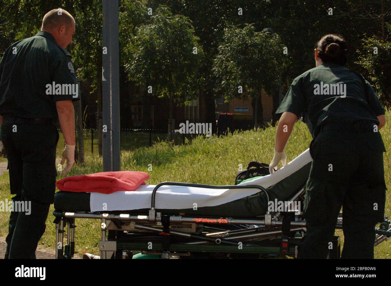 Ambulance staff prepare a stretcher for use Stock Photo - Alamy