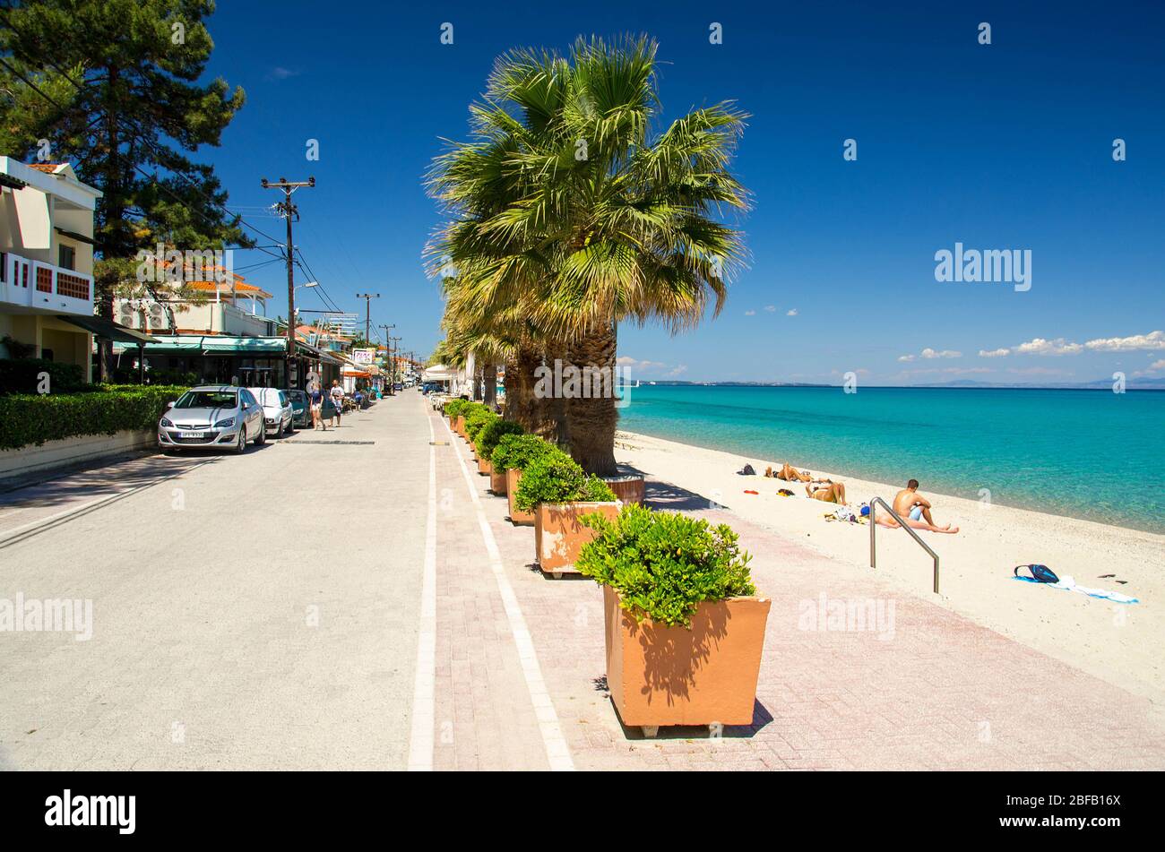 Pefkohori, Greece - May 16, 2016: Embankment, promenade and sandy beach ...