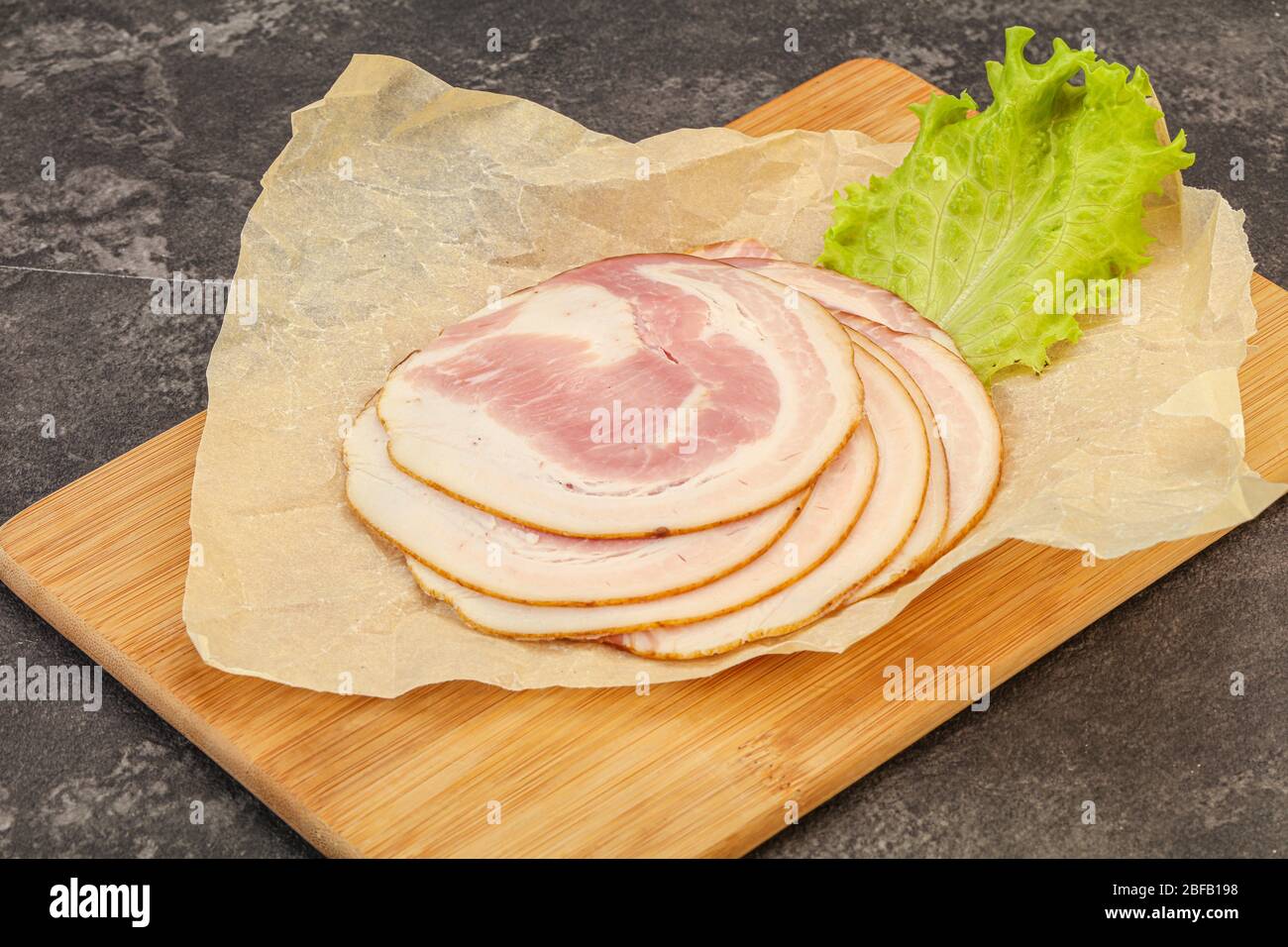 Sliced Italian Pancetta sausage over board Stock Photo - Alamy