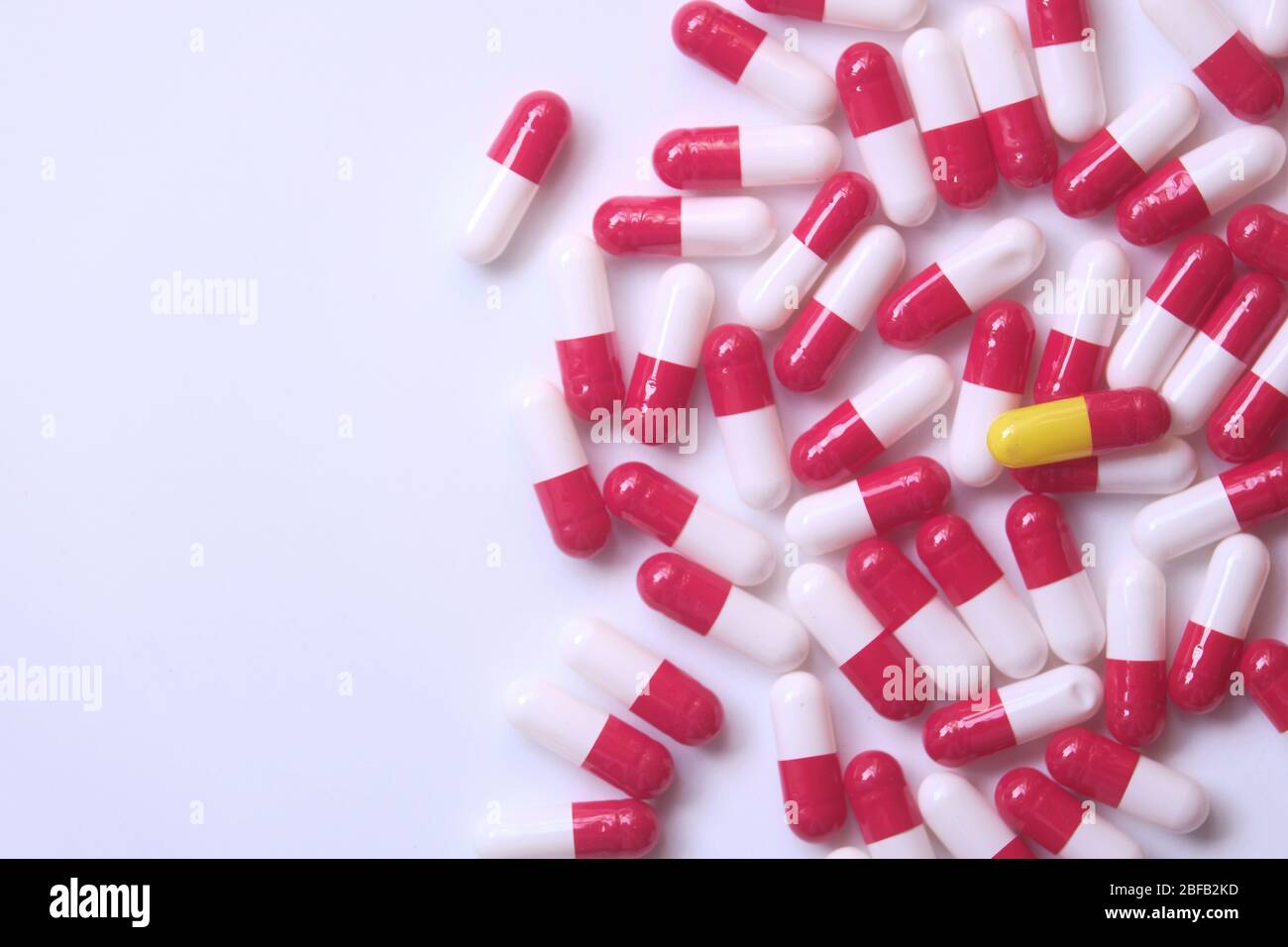 close up of capsules spilling form container Stock Photo - Alamy