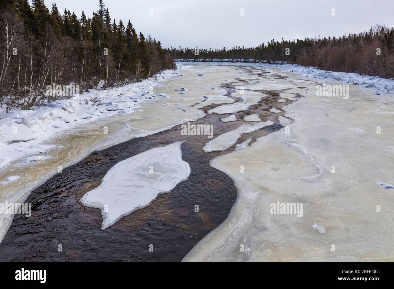 Buchans River carving through snow and ice in Buchans, Newfoundland ...