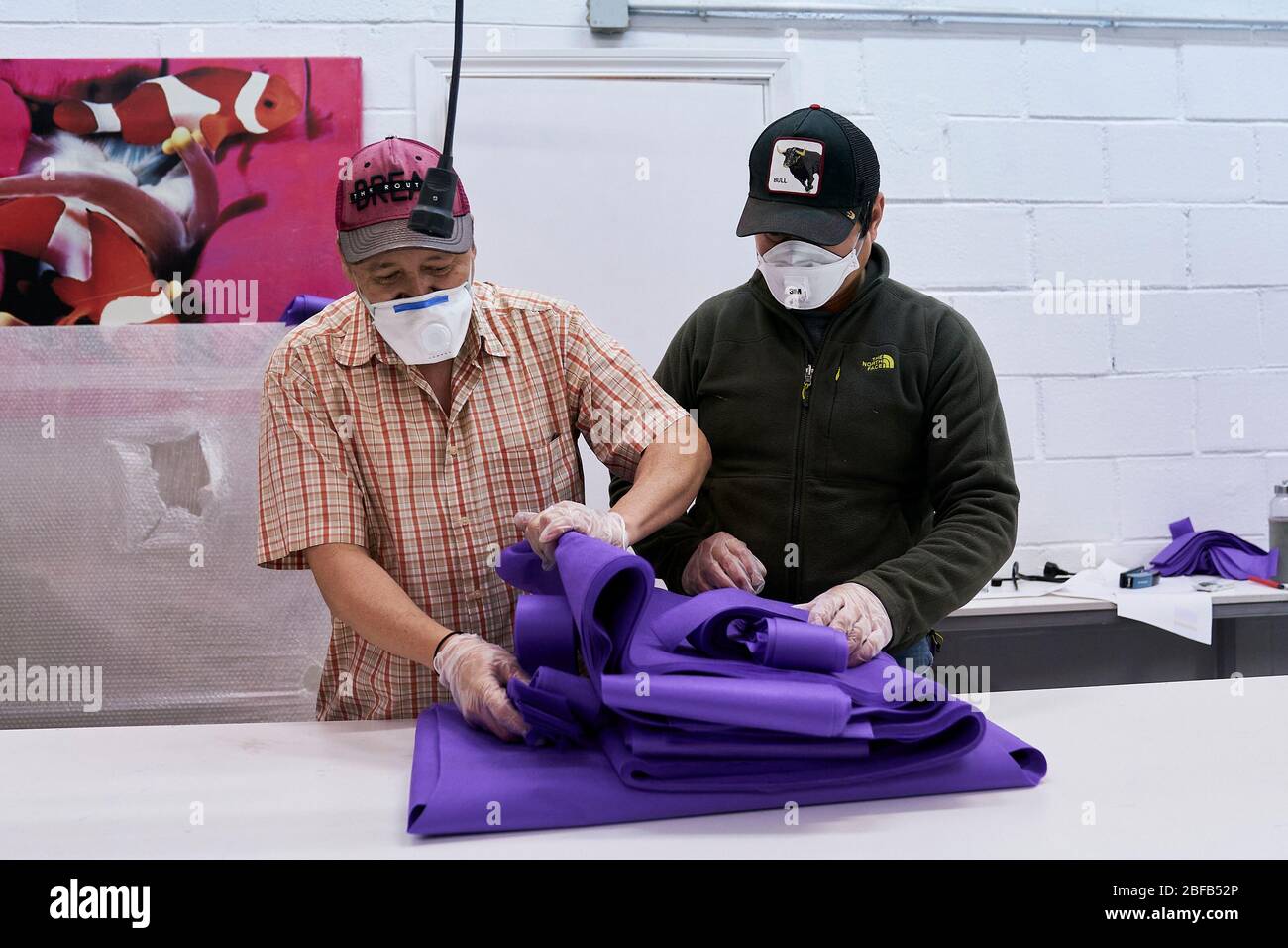 Volunteers wearing face masks as a preventive measure against the covid ...