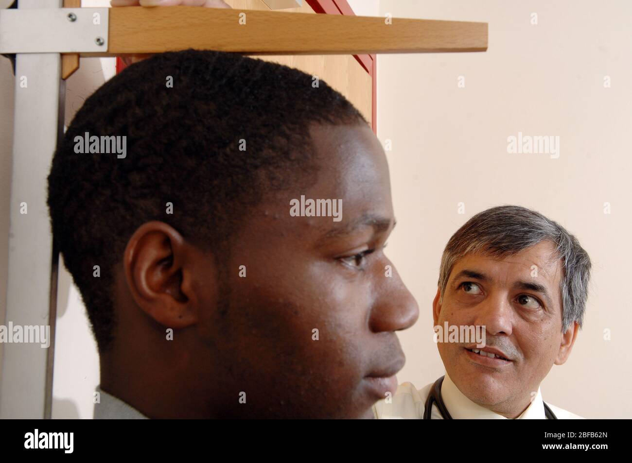 A GP measures the standing height of a man(Model released Stock Photo ...