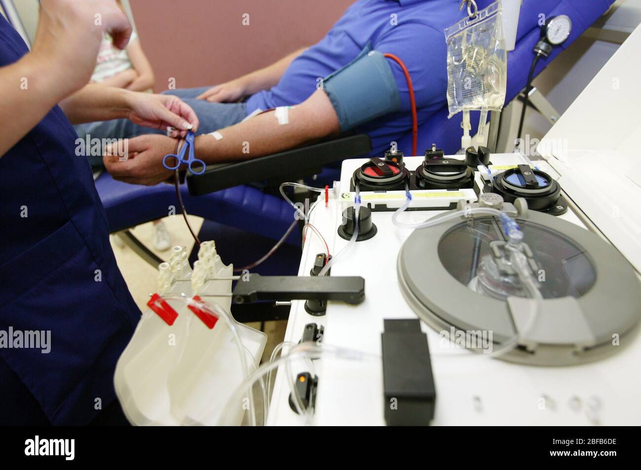 A nurse connects a patient to the Haemonetics MCS. This machine ...