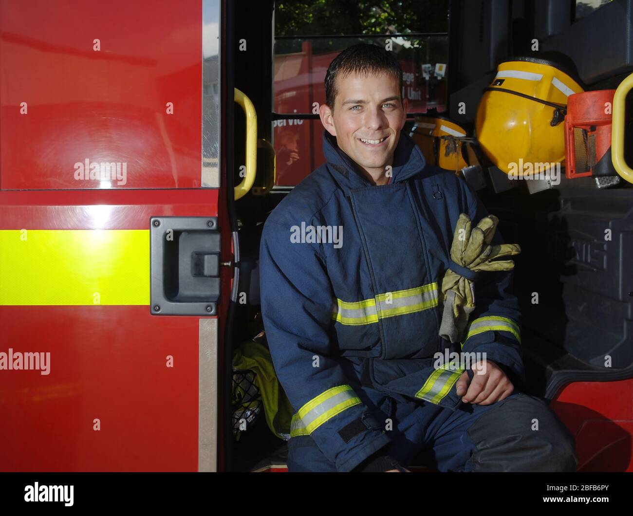 A young smiling firefighter from the Hertfordshire Fire & Rescue ...