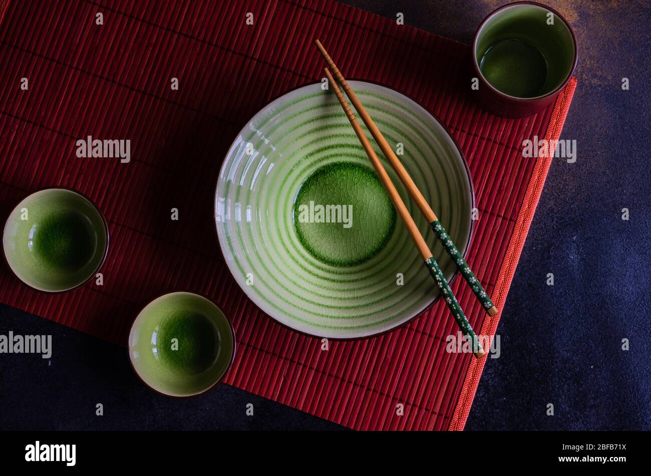 Table setting for asian cuisine dish on rustic background with copy ...