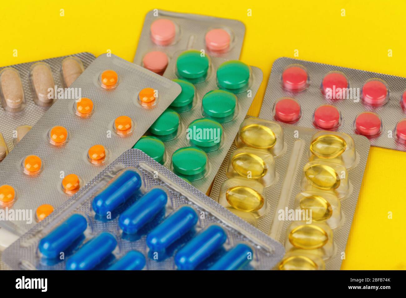 group of multi-colored pharmaceutical medication and medicine pills in ...