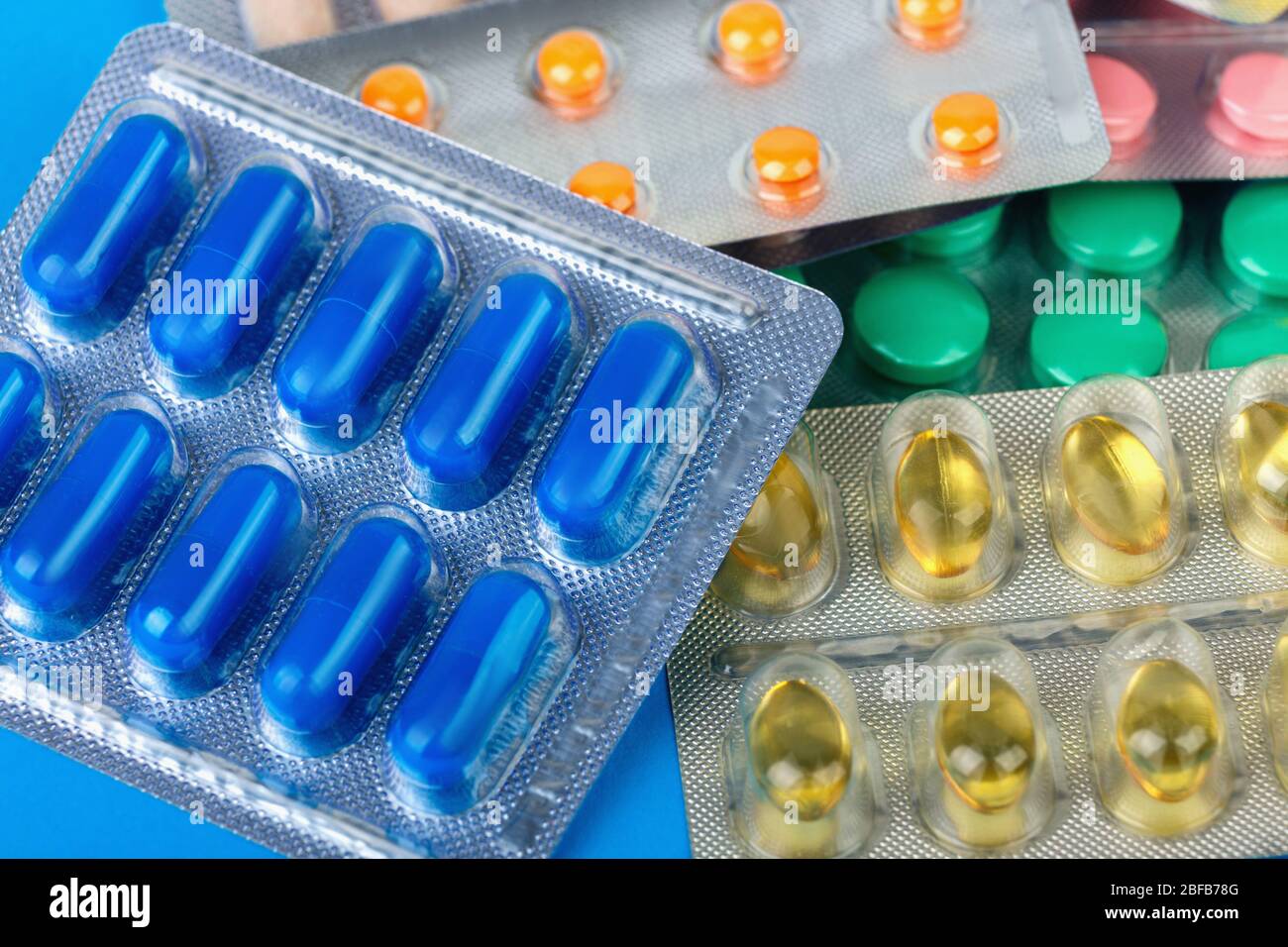 group of multi-colored pharmaceutical medication and medicine pills in ...