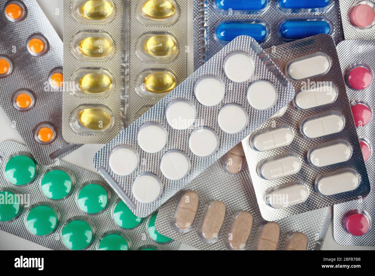 group of multi-colored pharmaceutical medication and medicine pills in ...