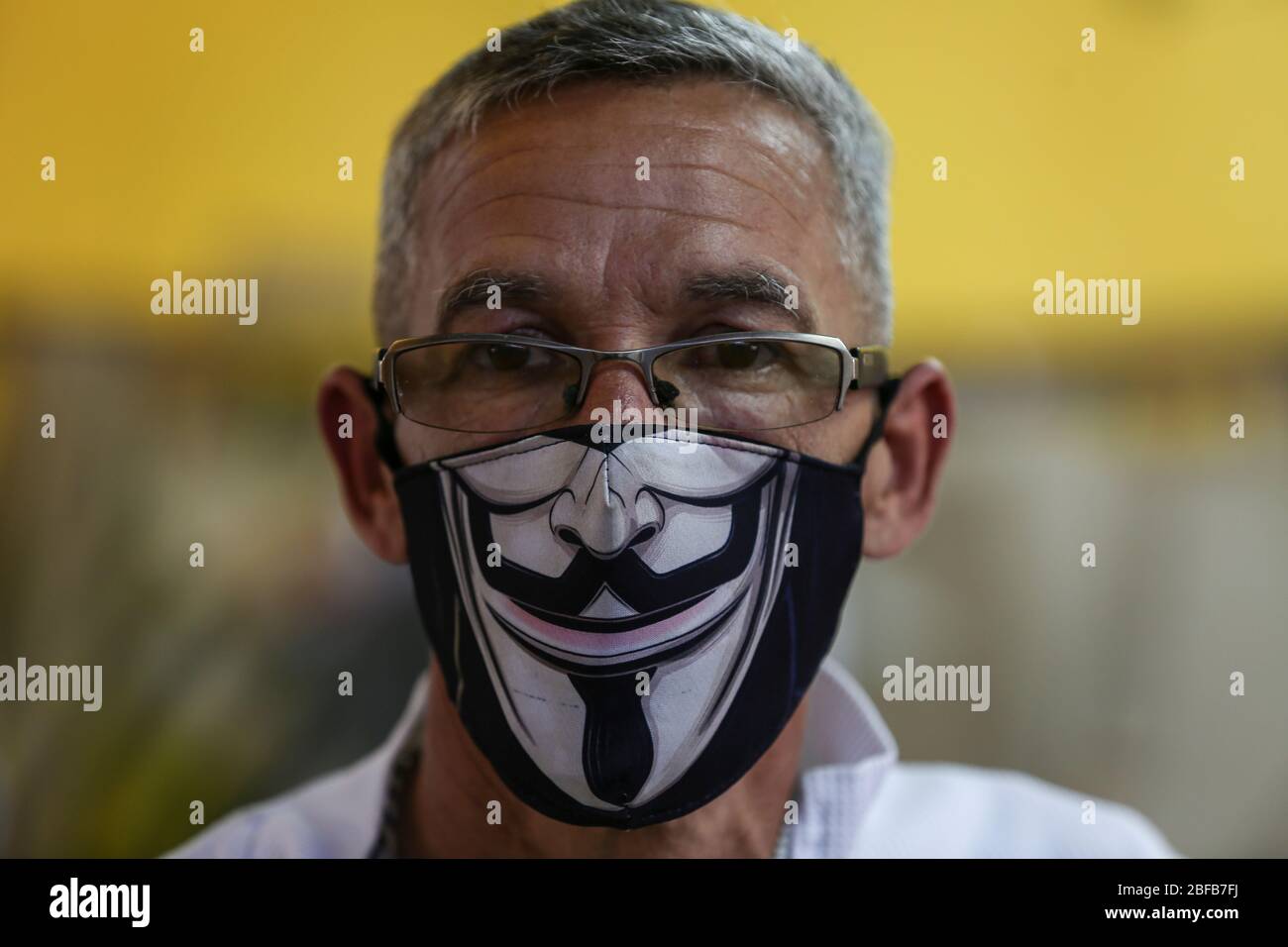 Young man wearing anonymous mask hi-res stock photography and images ...