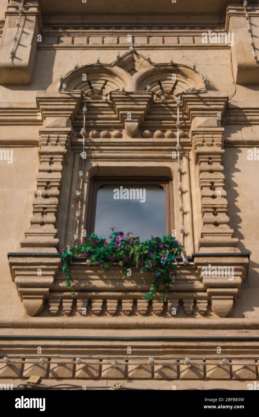 Beautiful vintage window on an old building with fresh flowers on a ...