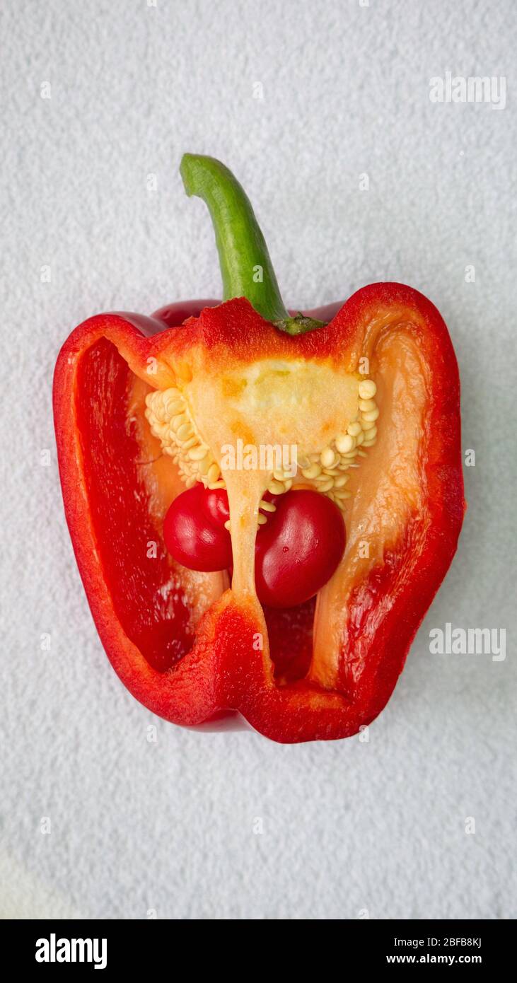 Red pepper cut in half with small paprika inside,white background Stock ...