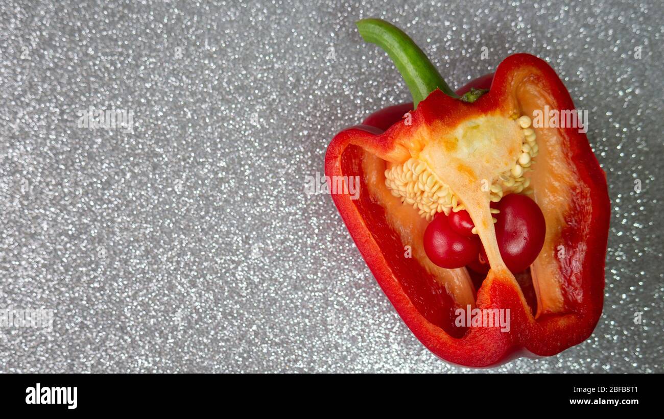 Two small bell peppers growing inside a red one, silver glitter ...