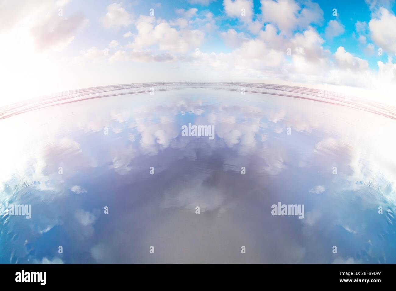 Cloudscape and cloud reflection in the water of the ocean on California ...