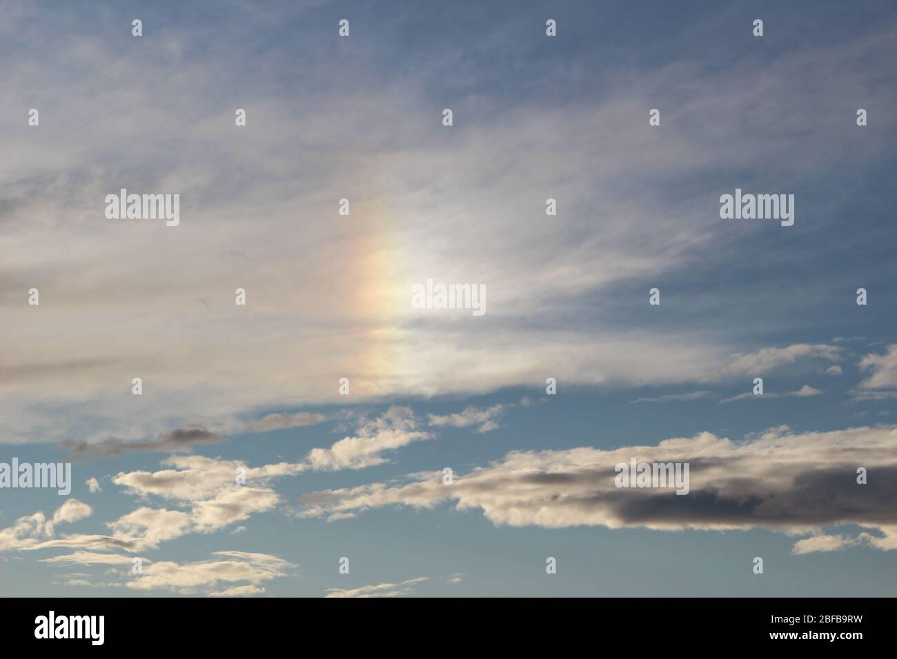 Partial rainbow refracted in high cloud on a spring evening Stock Photo ...