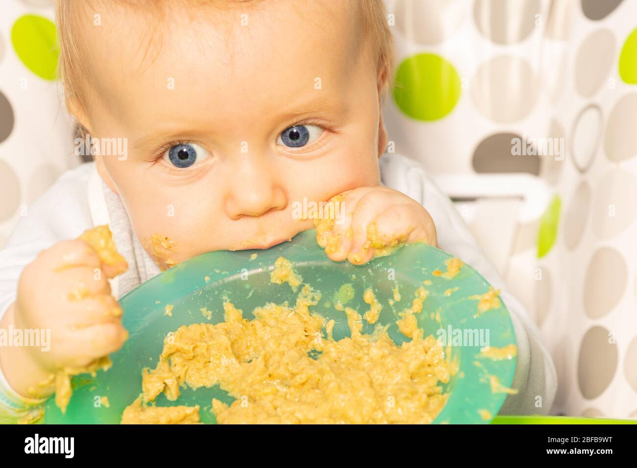 Toddler baby boy play with porridge plate instead of eating properly ...