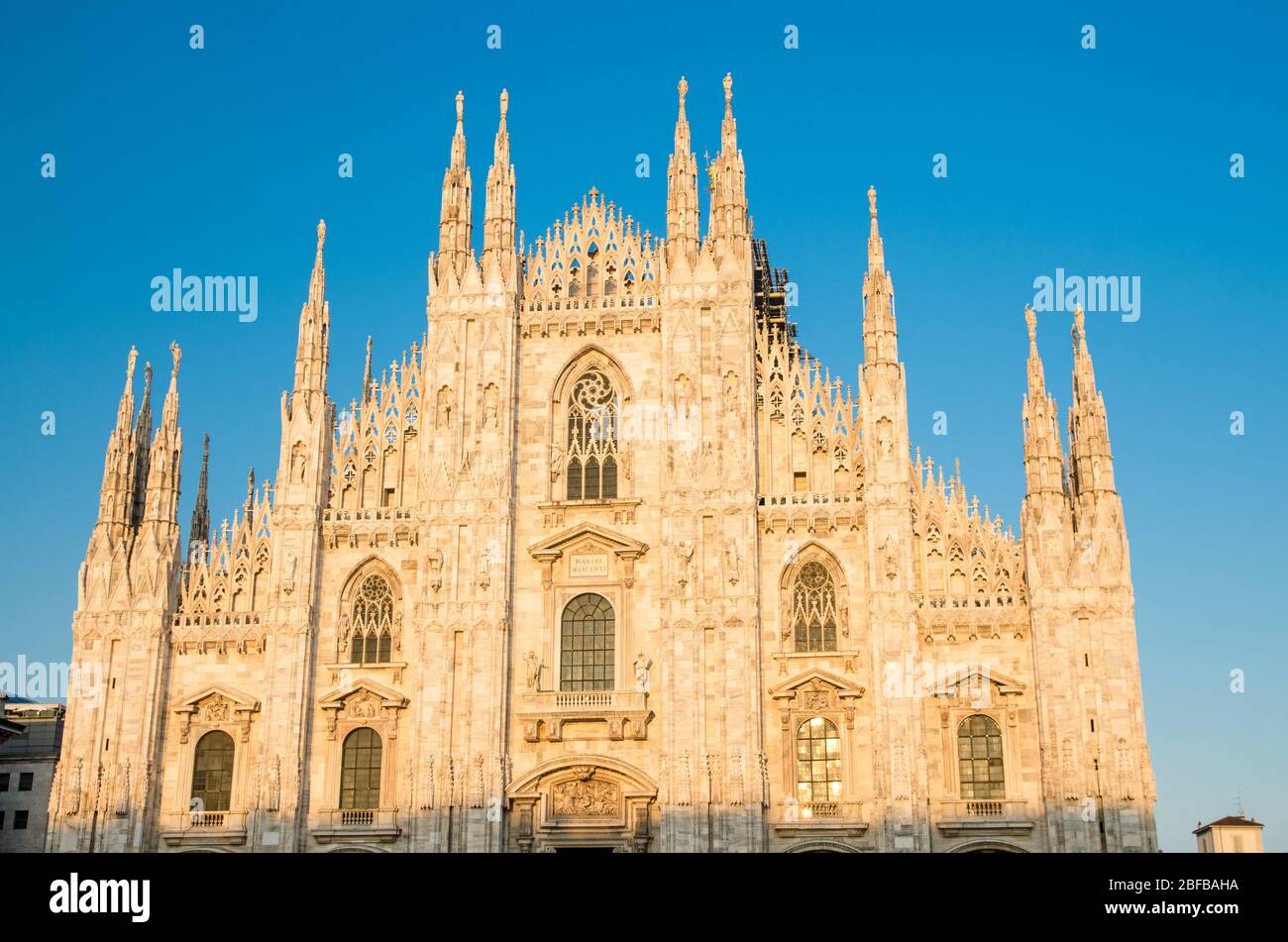 Duomo di Milano cathedral facade with white walls, high windows, spires ...