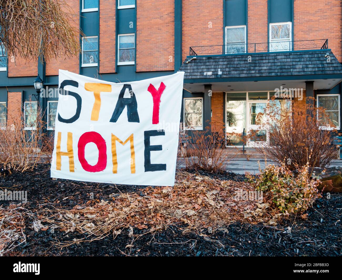 Stay Home banner outside an apartment building in downtown of ...