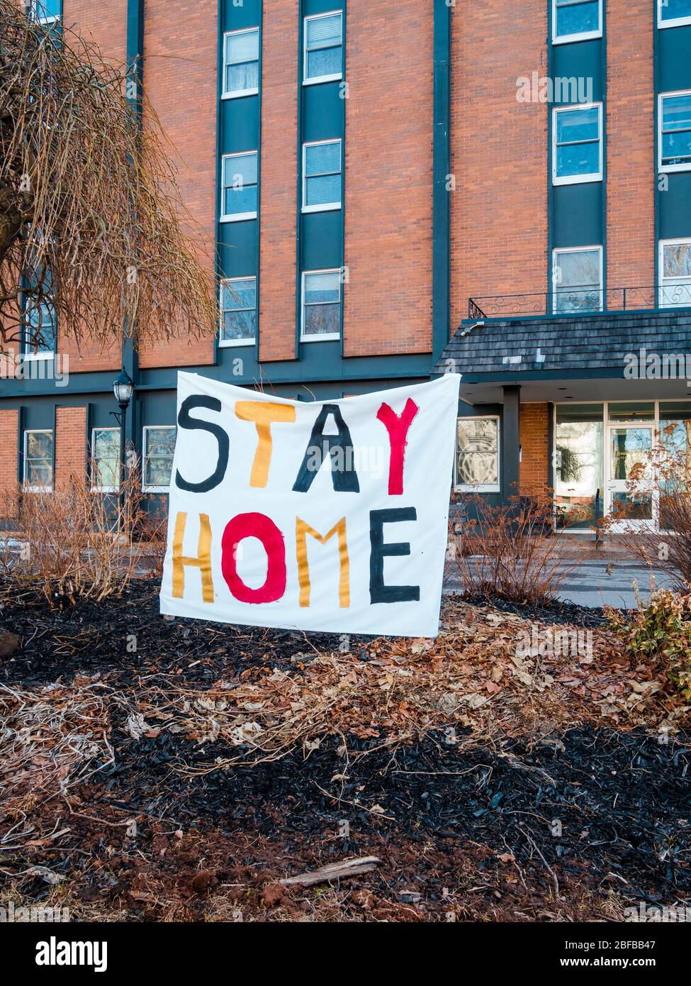 Stay Home banner outside an apartment building in downtown of ...