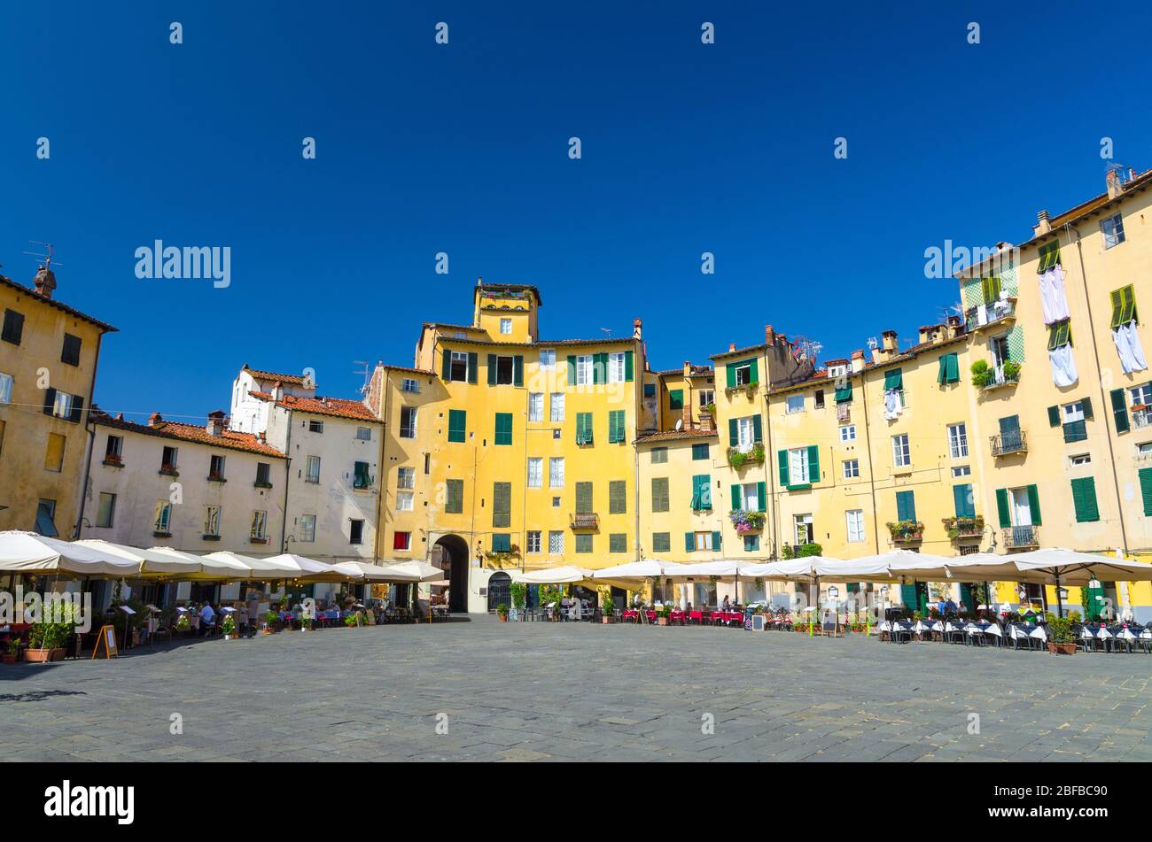 Piazza dell Anfiteatro square in circus yard of medieval town Lucca ...